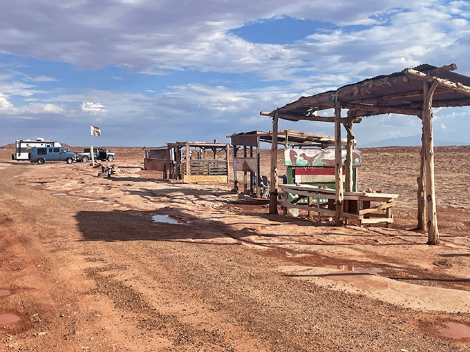 Simple wooden structures house local vendors selling handcrafted souvenirs &ndash; connecting past and present on Navajo land.