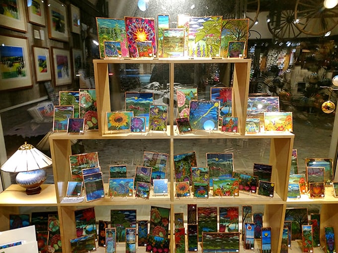 Colorful stained glass catches the light in the window display, transforming ordinary sunlight into a kaleidoscope of Vermont-inspired art.