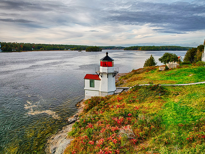 The lighthouse stands sentinel over the Kennebec River, its weathered exterior telling tales of countless storms weathered.