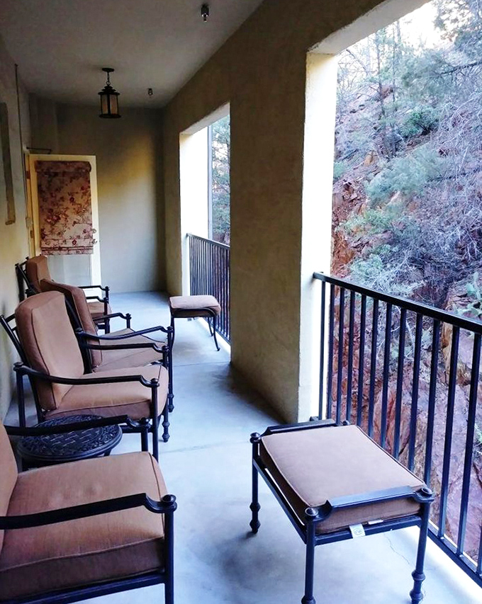 The hotel's balcony offers breathtaking views of Verde Valley below – a perfect spot for contemplating both the landscape and what made that noise in your room last night.