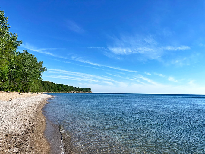 Lake Michigan's shoreline awaits at trail's end, where azure waters meet the sandy beach in a breathtaking grand finale.