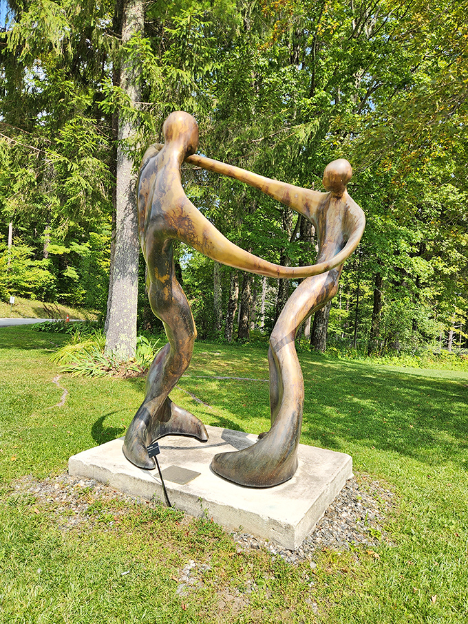 Two bronze figures locked in an eternal dance, their fluid forms capturing human connection in a moment of perfect balance.