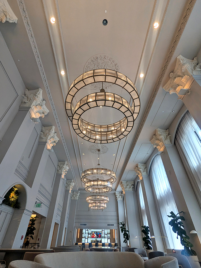 Look up! The lobby's spectacular chandeliers and ornate ceiling details transport visitors to Detroit's glamorous golden age.