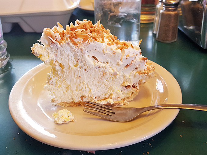 Behold the coconut cream pie, a towering testament to the power of dessert, topped with toasted coconut and enough whipped cream to make your dentist nervous.