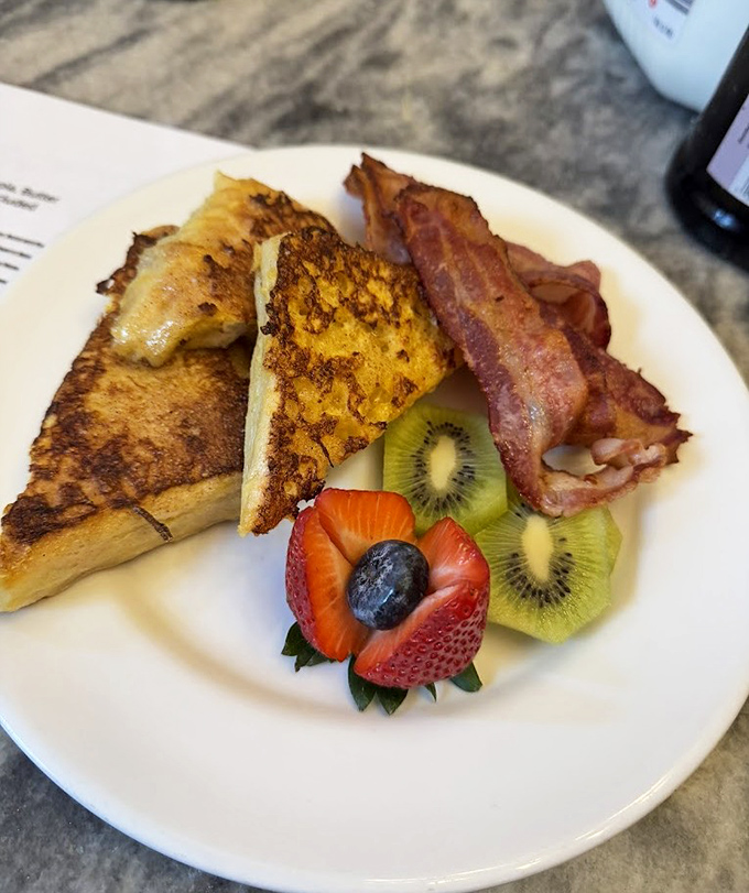 French toast that makes your kitchen attempts look like amateur hour, paired with bacon that's achieved the perfect crisp-to-chew ratio.