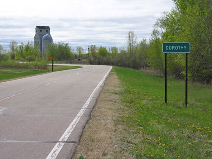 A simple gravel path leads to weathered buildings, inviting visitors to slow down and discover the subtle charms of this unassuming hamlet.