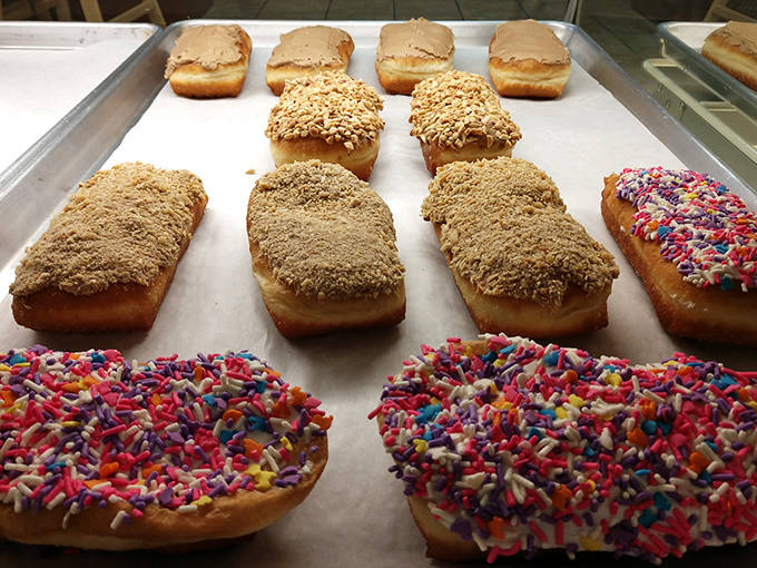 Long johns lined up like sweet soldiers, each one frosted to perfection. These aren't just donuts &ndash; they're edible works of art.
