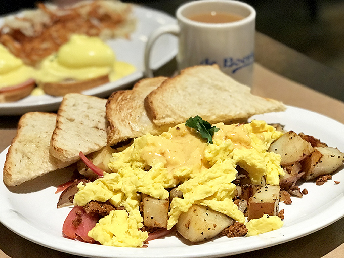 Breakfast perfection on a plate &ndash; fluffy scrambled eggs nestled beside crispy potatoes and toast, proving simple food done right is sometimes the most satisfying.