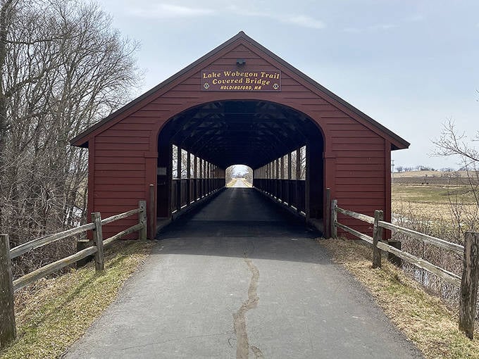 Sunshine plays peek-a-boo through the bridge's windows, creating a dappled light show on the pathway within.