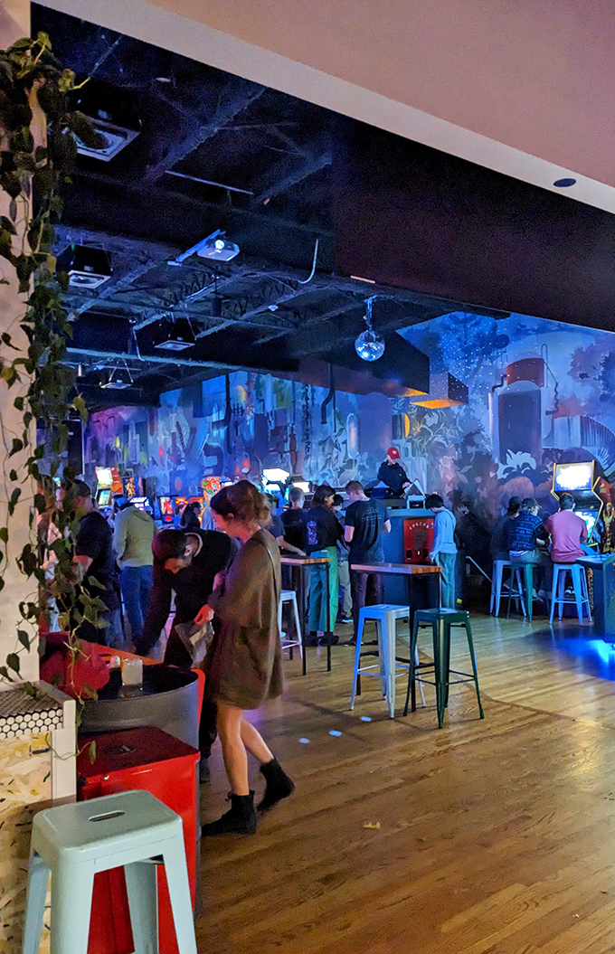 The arcade floor buzzes with energy as players navigate between games, creating a community connected by joysticks and shared childhood memories.