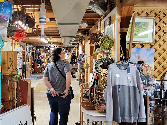 Treasure hunters browse with quiet concentration, each on their own quest for that perfect find among the barn's countless curiosities.