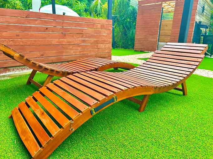 This wooden lounger understands the assignment: maximum comfort, optimal sun exposure, zero effort required from you.