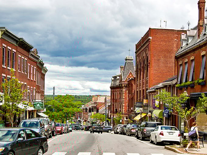 Belfast's charming main street features historic buildings with American flags, creating a classic small-town New England scene.