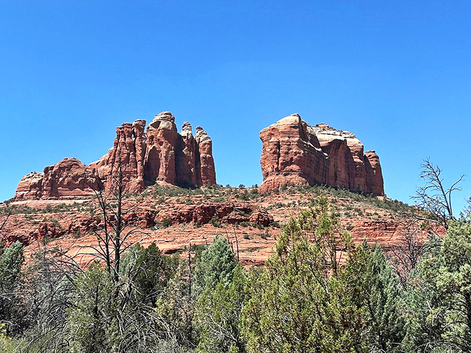 Majestic red rock formations rise from the desert floor in Sedona, their striking silhouettes creating a landscape that feels spiritual and timeless.