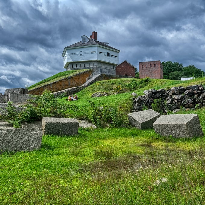 Grassy slopes leading to the harbor show how history and natural beauty can share space perfectly for centuries.