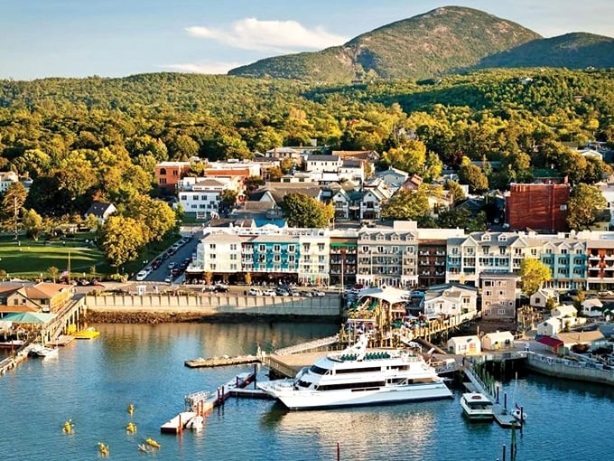 Bar Harbor glows in golden light, with mountains forming a dramatic backdrop to this gateway to Acadia National Park.