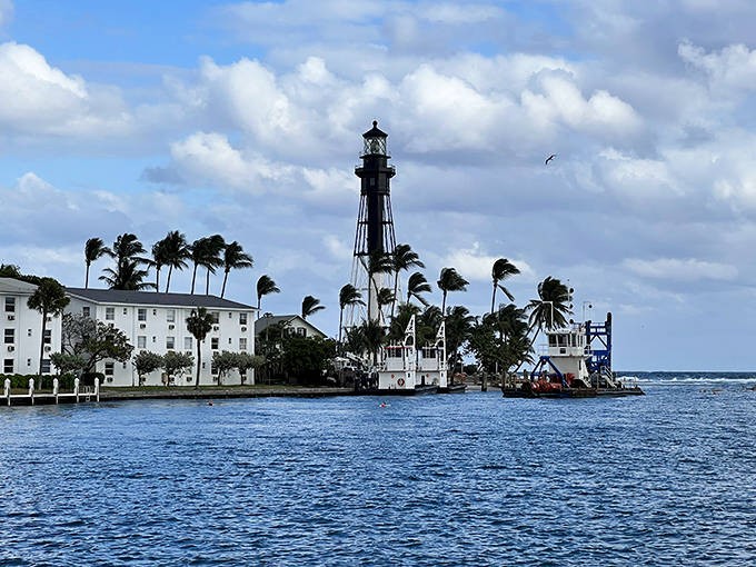 A closer view of Hillsboro Lighthouse showcases its distinctive design against a perfect blue sky. Its powerful beam can be seen 28 miles away at sea.