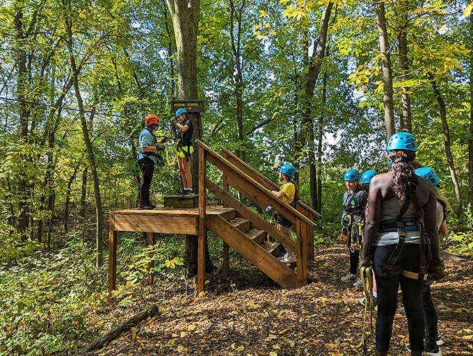Helmeted adventurers prepare to soar through the treetops at Kerfoot Canopy Tour, experiencing Minnesota from a bird's perspective.