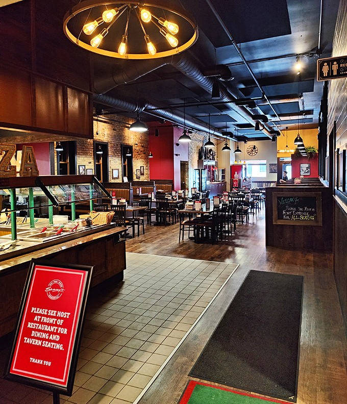 Inside Sammy's, exposed brick walls and warm lighting create the perfect atmosphere for enjoying Minnesota's beloved square-cut pizza tradition.