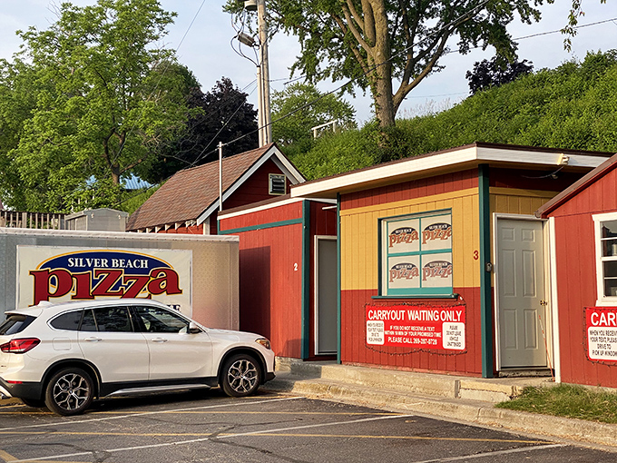 Silver Beach Pizza's colorful train depot building serves as both working station and beloved pizzeria, a unique dining experience worth the journey.