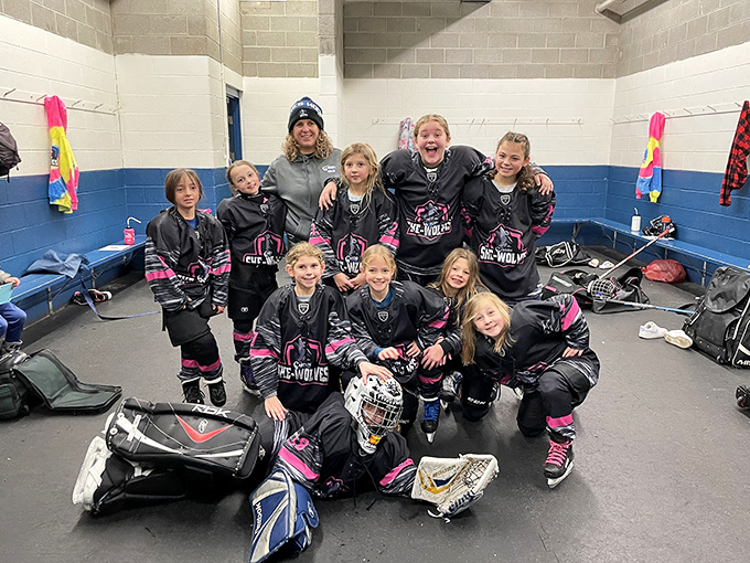 Young hockey players preparing for action – the bench area where strategies are planned and friendships are forged in the frost.