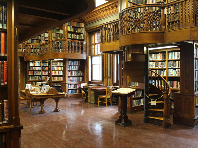 Two-story bookshelves stretching to the ceiling are basically a reader's version of heaven, assuming heaven has a really good card catalog system.