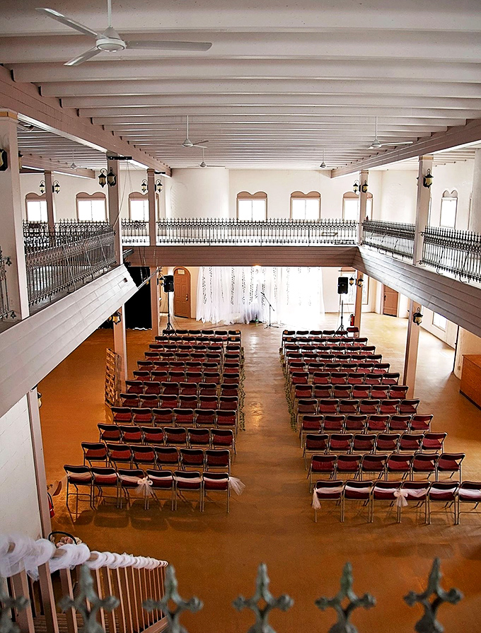 The castle's great hall transforms for events, where wooden balconies and open space create an atmosphere both grand and intimately welcoming.