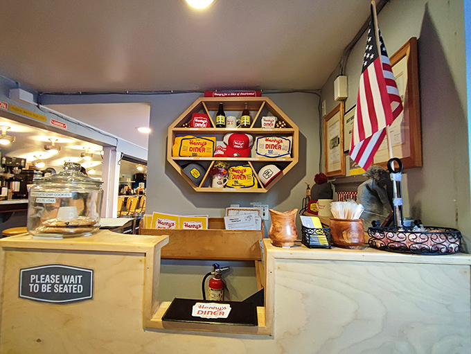 The command center of diner operations, where coffee mugs are never empty and Henry's merchandise reminds you to take the experience home.