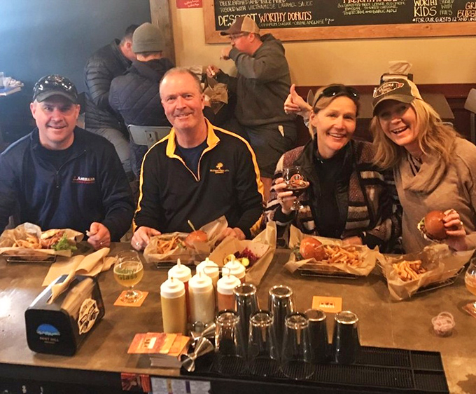 Happy diners sharing good food, good drinks, and good times &ndash; the universal language of burger appreciation transcends all barriers.