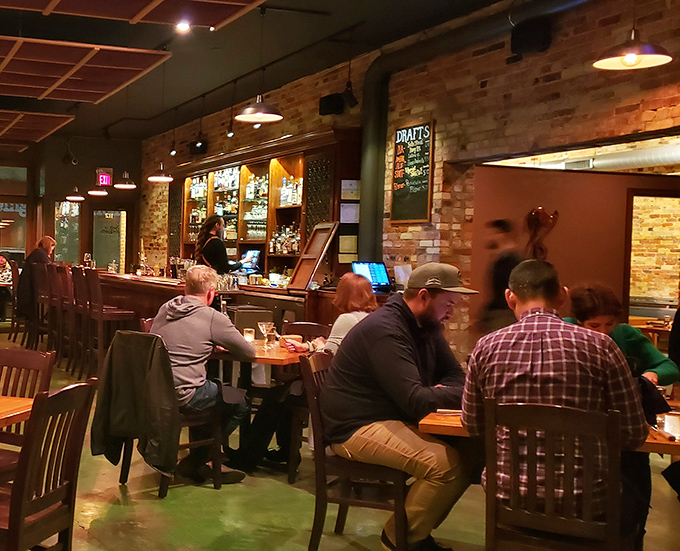 The dining room hums with conversation and laughter as patrons gather around wooden tables, sharing food and creating memories.