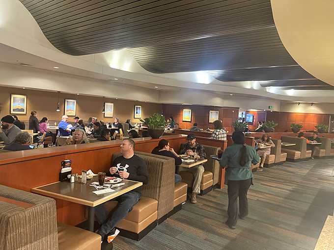 The spacious dining room buzzes with conversation as diners enjoy the buffet's offerings in comfortable booths and well-spaced tables.