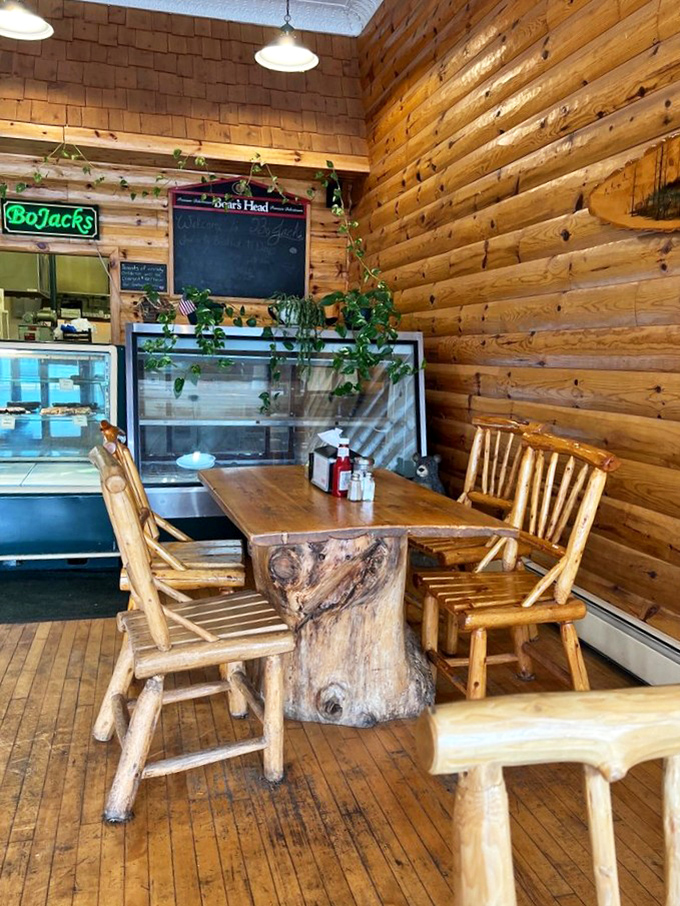 Rustic log tables and chairs that look harvested directly from the forest create dining spaces that feel like eating in a particularly delicious treehouse.