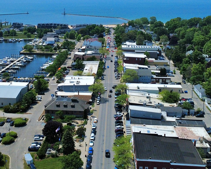An aerial view reveals Frankfort's perfect positioning between lush greenery and the vast blue of Lake Michigan.