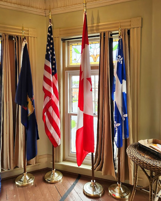 Four flags, one mission: bringing nations together through books. This patriotic display celebrates the library's unique international status.