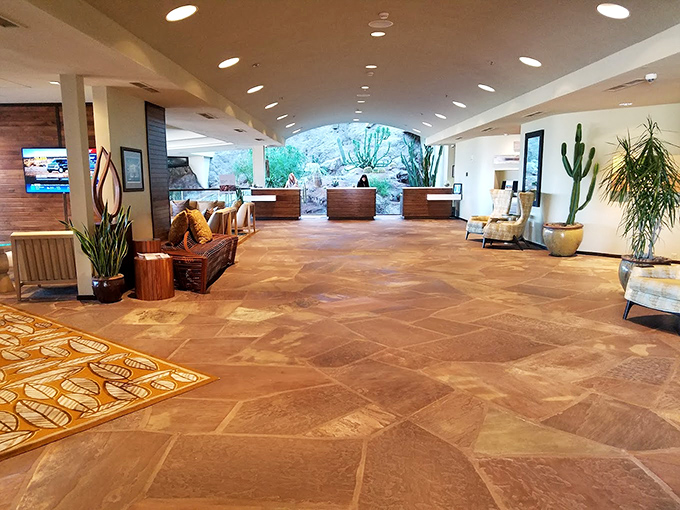 The resort's grand lobby welcomes with warm desert tones and native plants, a sophisticated gateway to your waterfall dining adventure.