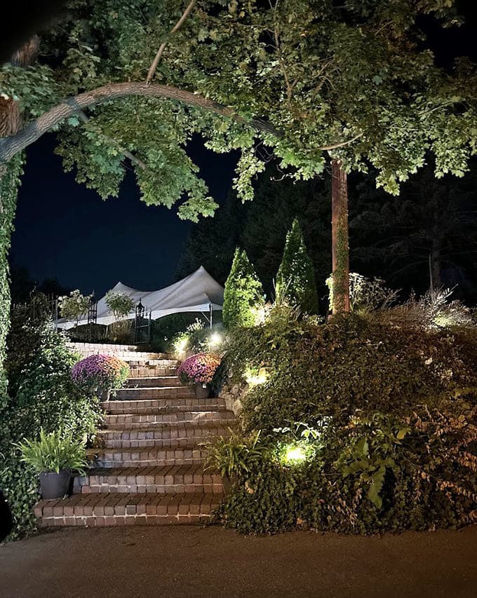 Evening lighting transforms the gardens into something from a fairy tale, assuming fairy tales included excellent landscaping and modern electrical work.