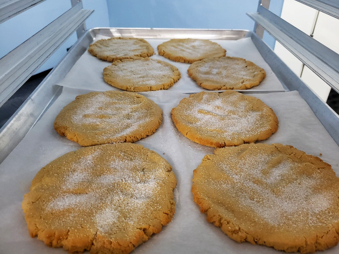 Sugar-dusted peanut butter cookies fresh from the oven, their crackled tops promising that perfect chewy-crisp texture that haunts cookie dreams.