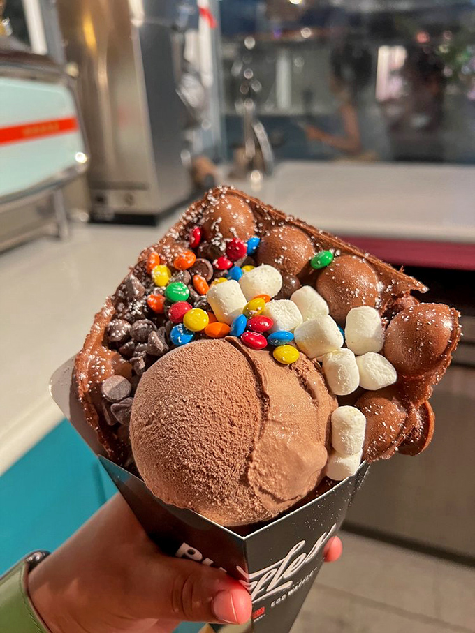 Ice cream goes maximalist with this creation, where chocolate scoops become merely the canvas for a carnival of toppings.