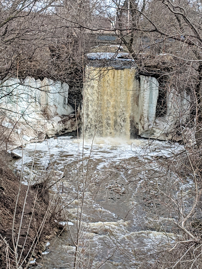 Winter transforms Wequiock Falls into nature's ice sculpture garden, where frozen cascades create a breathtaking crystalline display.