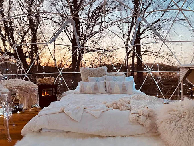 Fluffy pillows and textured blankets create layers of comfort inside the geometric sanctuary, perfect for afternoon lounging.