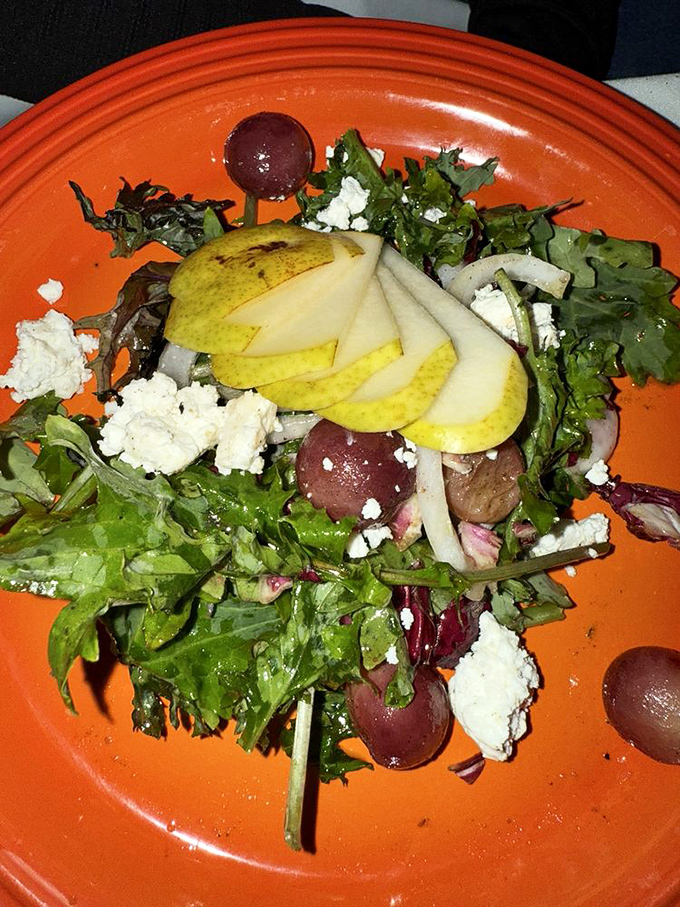 A vibrant kale salad dotted with pear slices and cheese crumbles &ndash; proof that "eating your greens" can be a pleasure, not a chore.