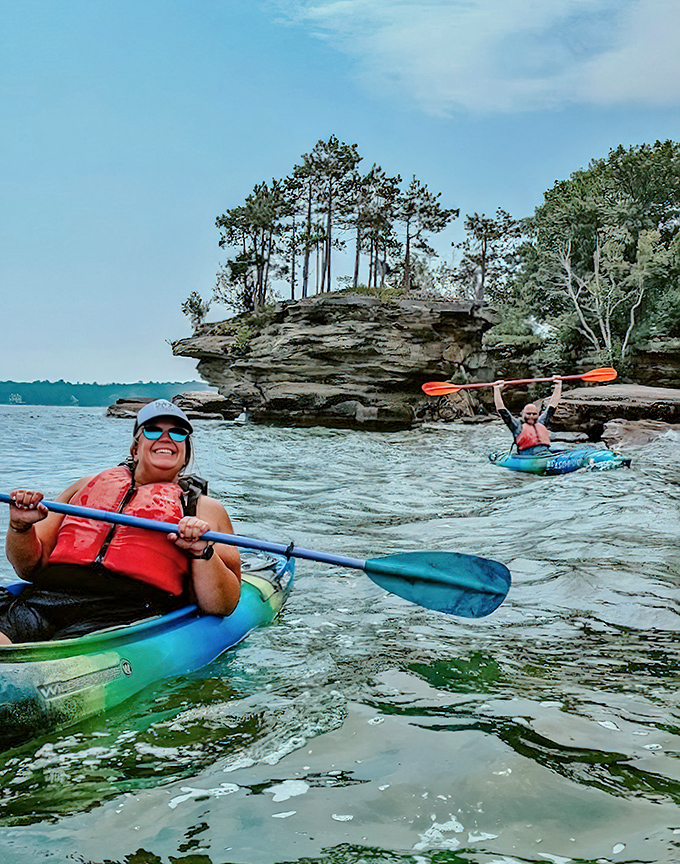 Colorful kayaks add a human element to this wild landscape, reminding us that some treasures are best earned through a bit of adventure.