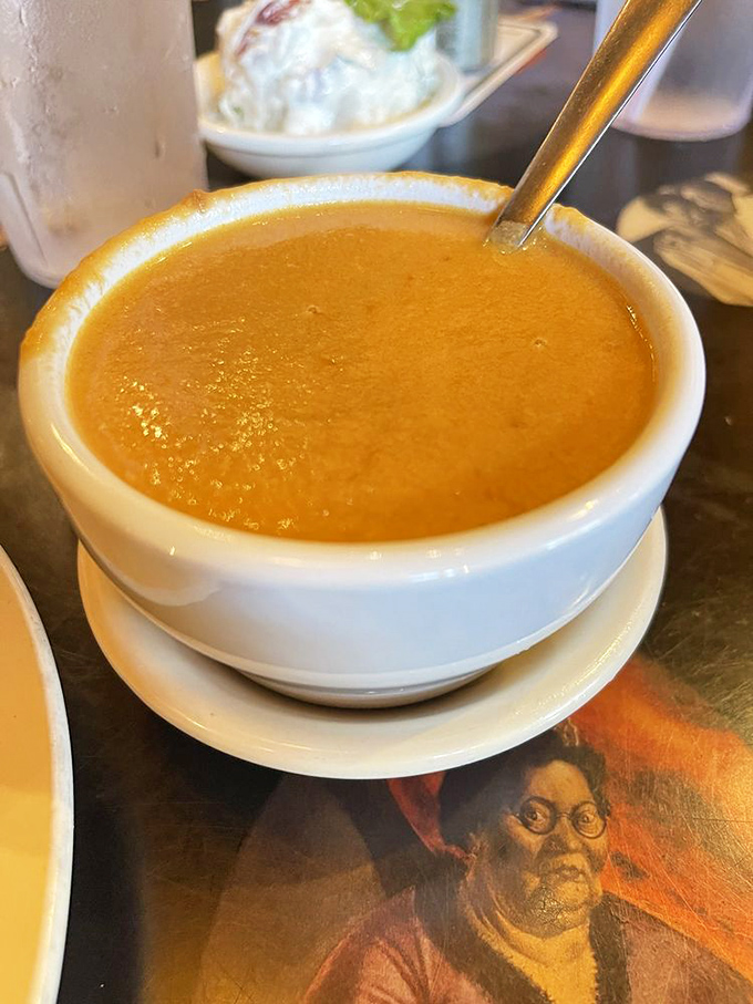 Their Lobster Bisque arrives unassuming in its white bowl, but that first spoonful reveals a velvety, complex seafood symphony worth savoring slowly.