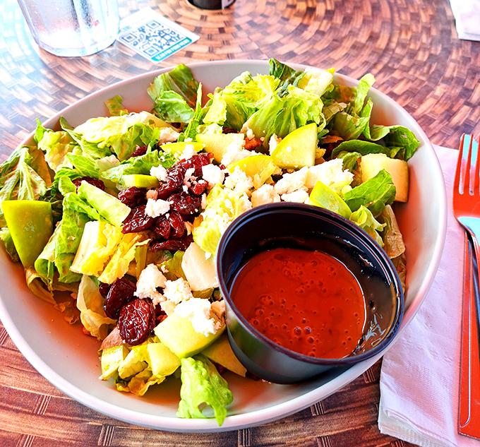 The Michigan Salad offers a refreshing counterpoint with dried cherries, apples, and candied pecans – virtuous enough to justify another round.