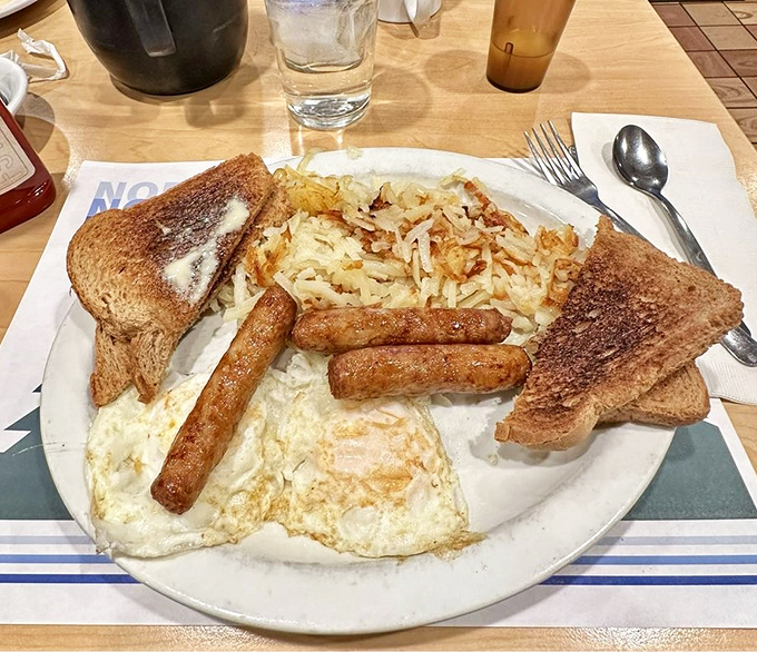The classic breakfast trinity: perfectly cooked eggs, crispy-yet-tender hash browns, and toast that's ready for its butter close-up.