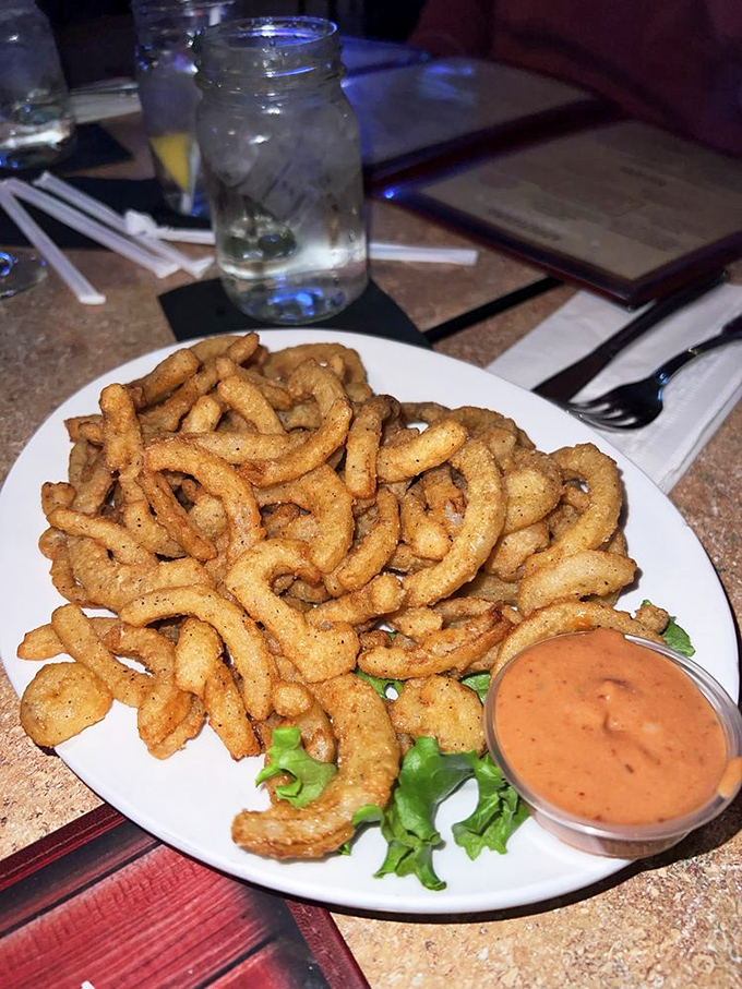 Onion rings that don't play games. Crispy, golden, perfectly seasoned, and served with a dipping sauce that might make you forget ketchup exists.