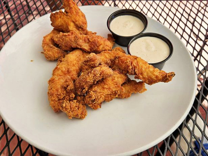 Golden-fried perch tenders arrive crispy and succulent, served with dipping sauces that elevate this comfort food to craft beer companion status.