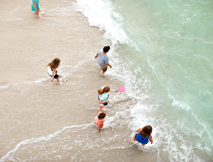 The ultimate kid-approved vacation activity: splashing in crystal clear waters while parents finally exhale and relax.