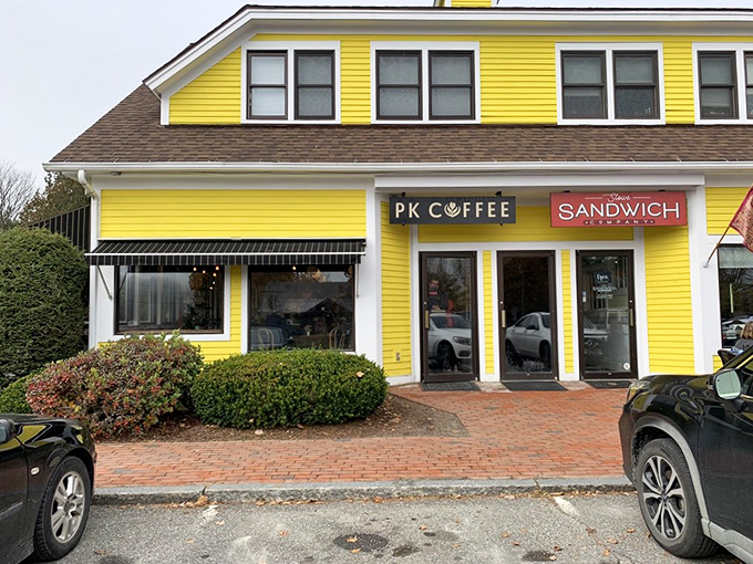 PK Coffee's cheerful yellow facade promises caffeinated salvation and sandwiches that make lunch an event rather than an obligation.