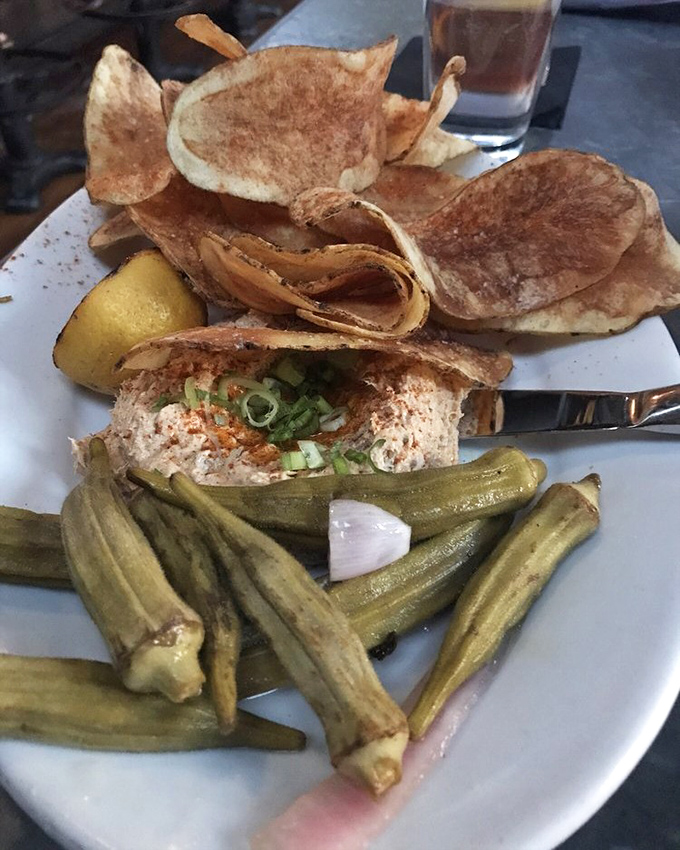 The smoked fish dip arrives with house-made potato chips and pickled okra &ndash; proof that the simplest appetizers often create the strongest memories.